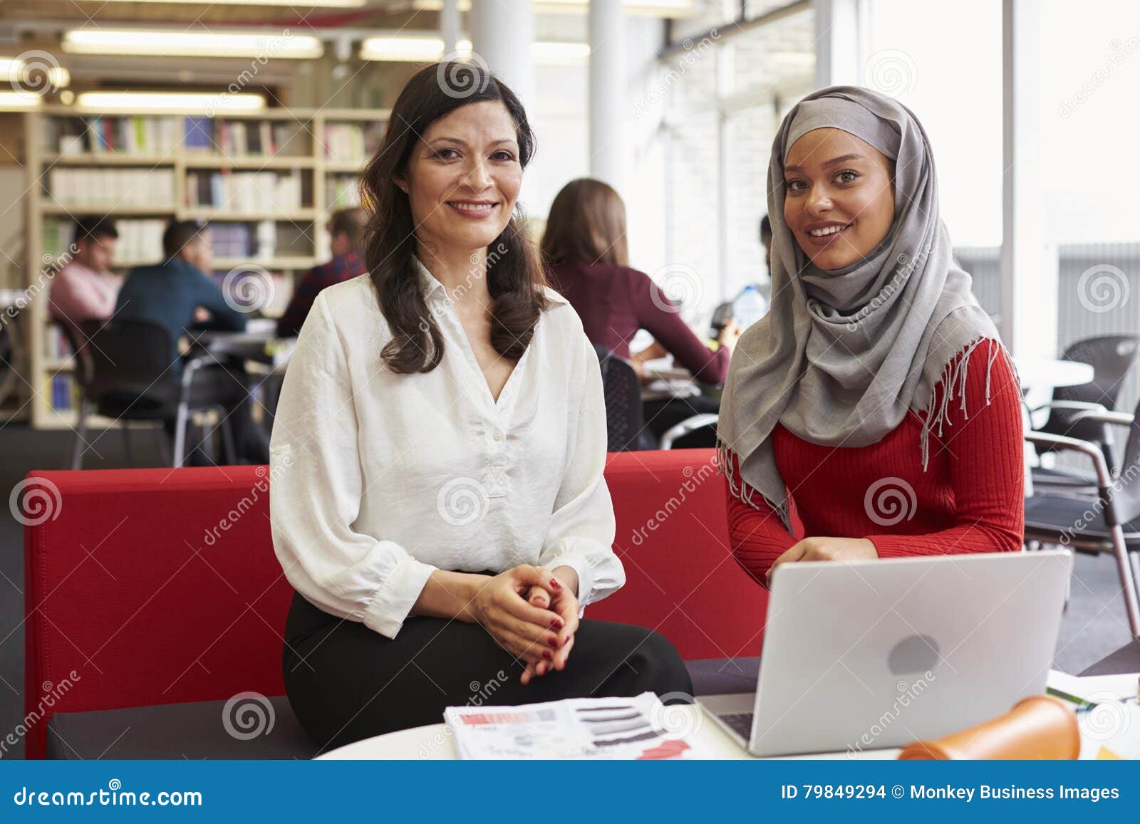 Female University Student Working in Library with Tutor Stock Photo ...