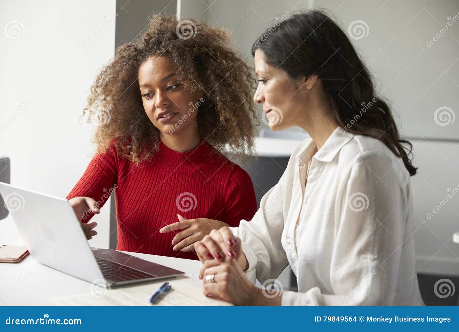 Female University Student Working One To One with Tutor Stock Photo ...