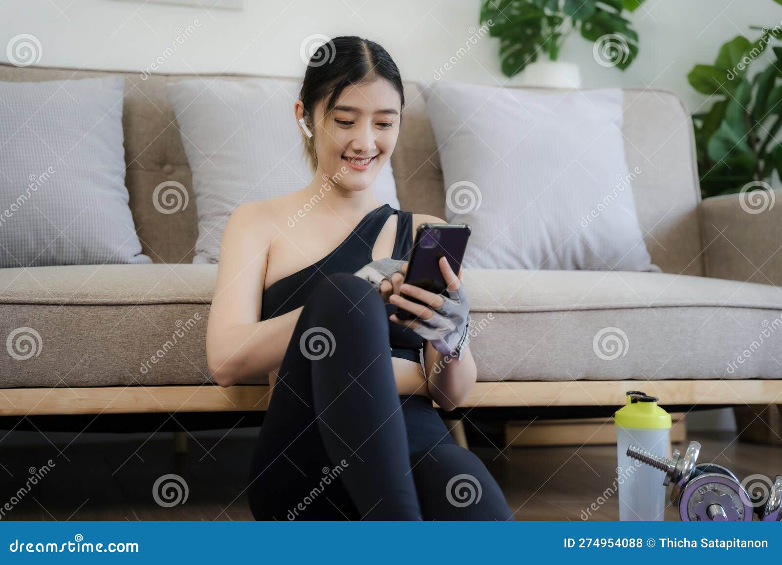 Female Using Smartphone during Workout at Home. Online Personal Trainer ...