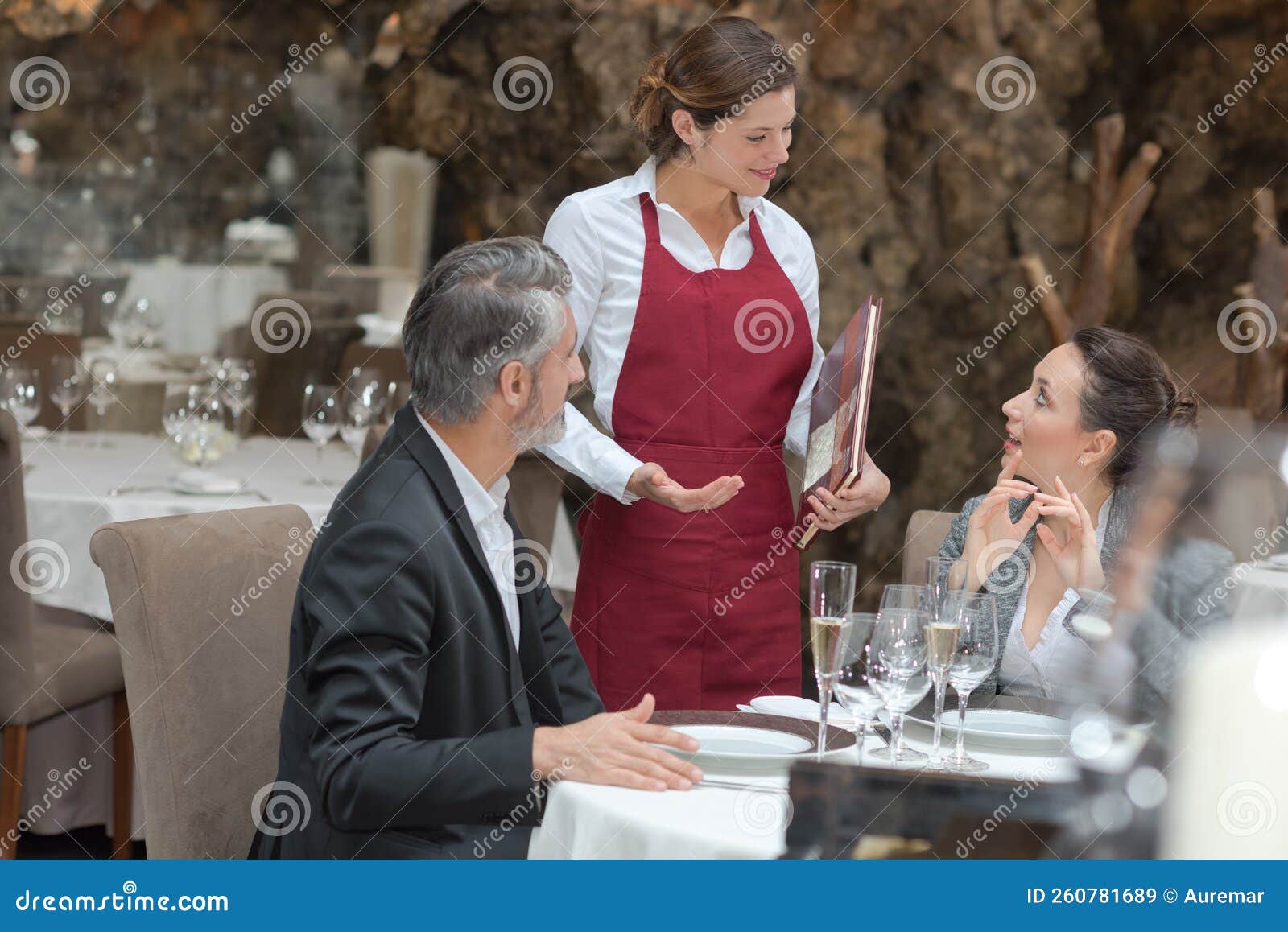 Female Waitress with Couple in Restaurant Stock Image - Image of flower ...