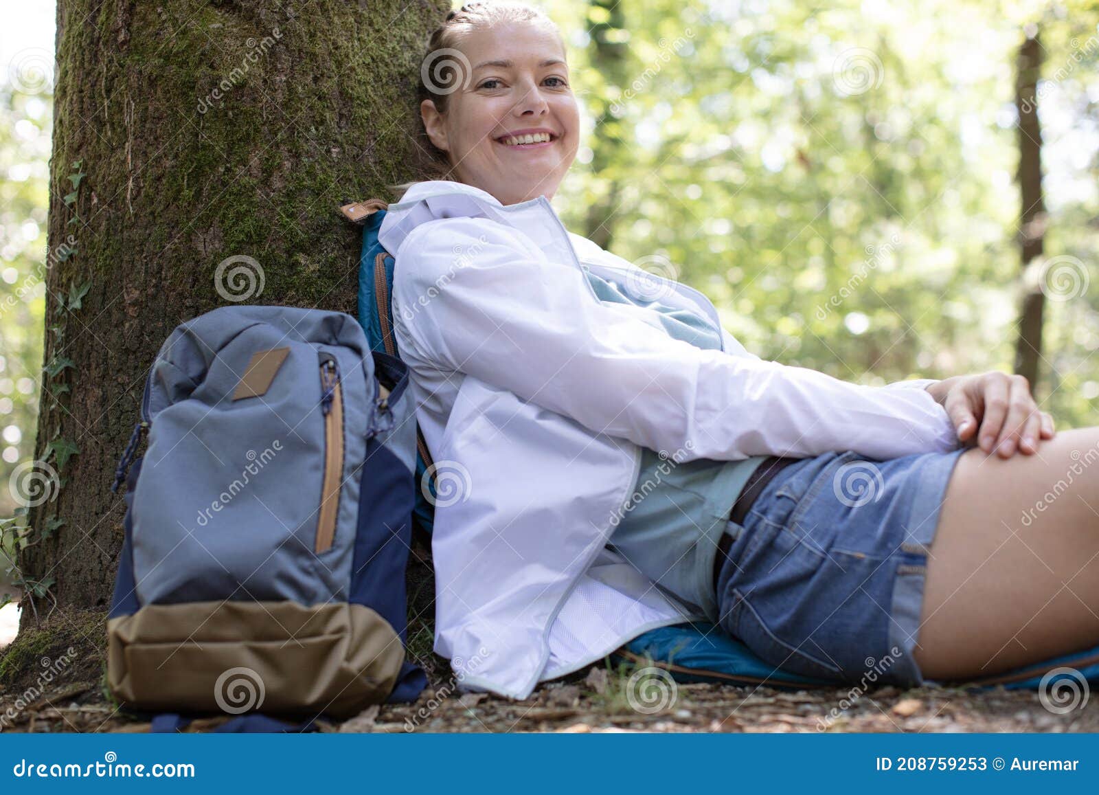 Female Walker Resting Against Tree Stock Image - Image of tired ...