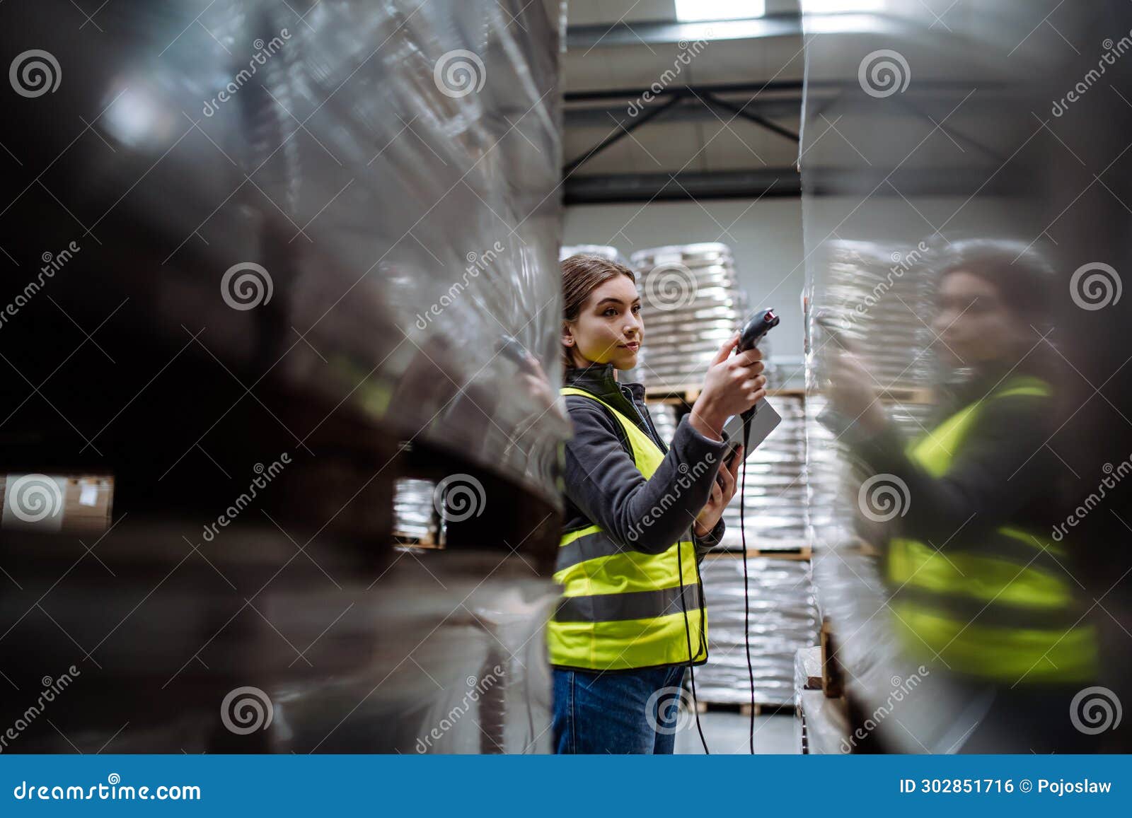 Female Warehouse Worker Holding Scanner, Scanning the Barcodes on ...