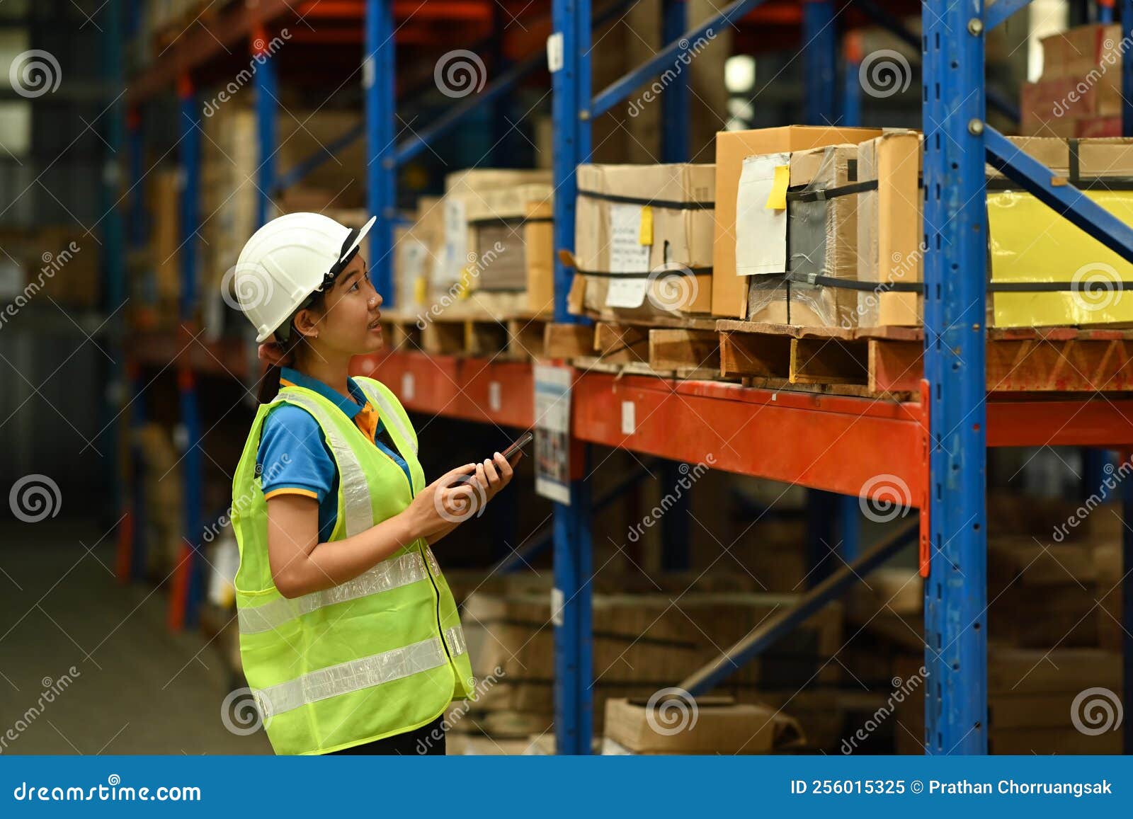 Female Warehouse Worker Wearing Hardhats and Reflective Jackets ...