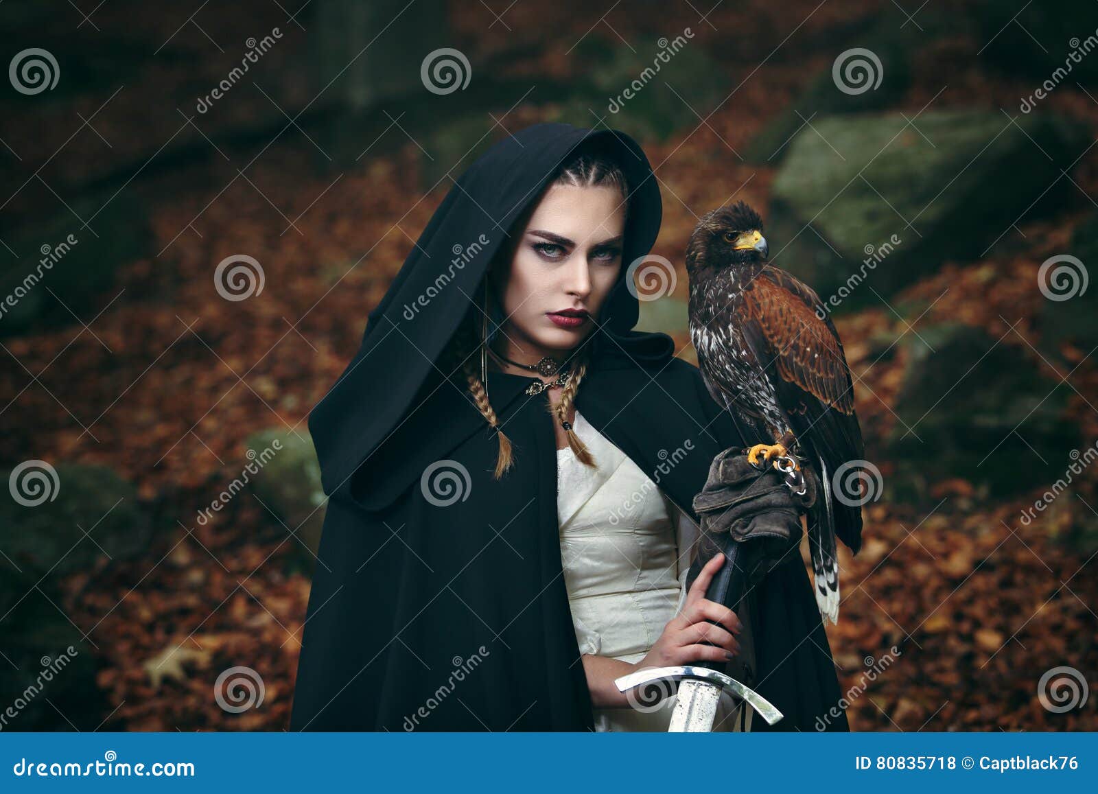 Female Warrior with Sword and Hawk Stock Photo - Image of hood, woods ...