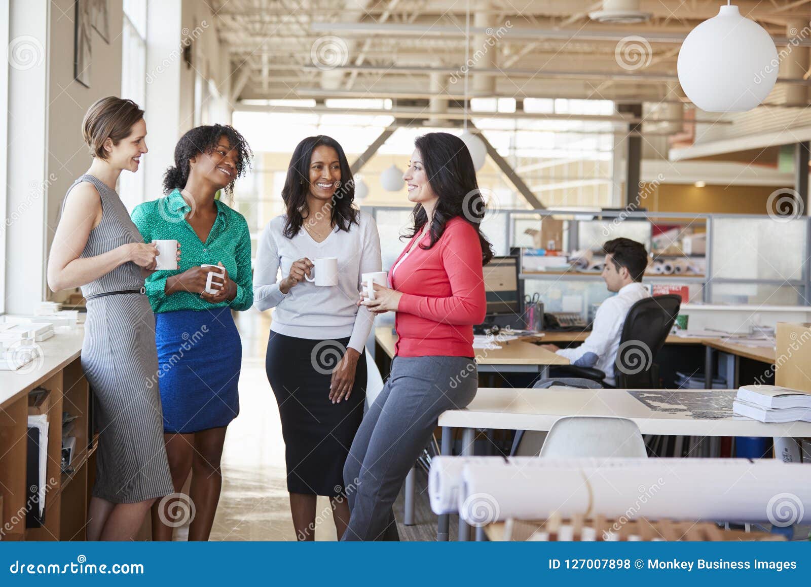 Female Work Colleagues Chatting Over Coffee in the Office Stock Photo ...