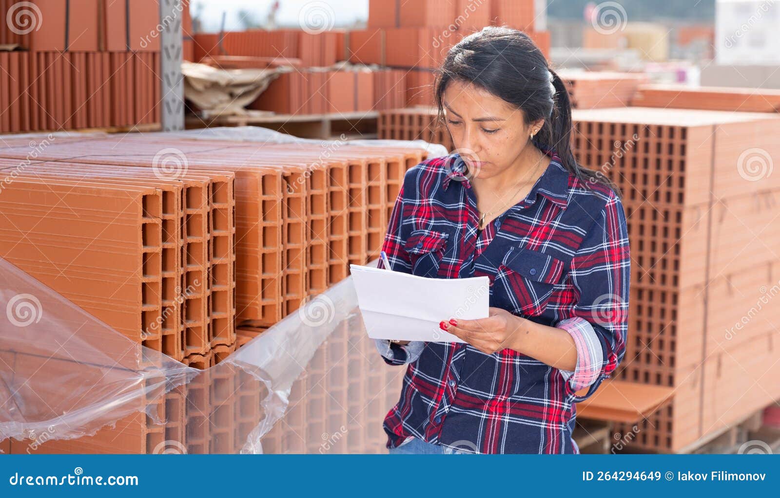 Female Worker Checking Quantity of Red Bricks in Warehouse Stock Image ...