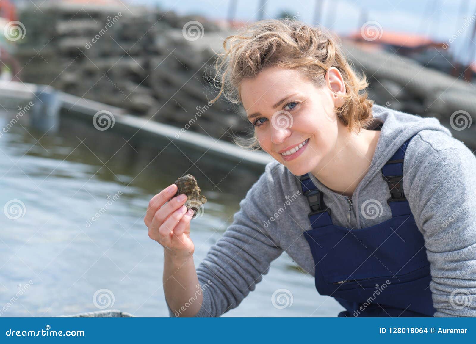 Female Worker Holding Shellfish Stock Photo - Image of background ...