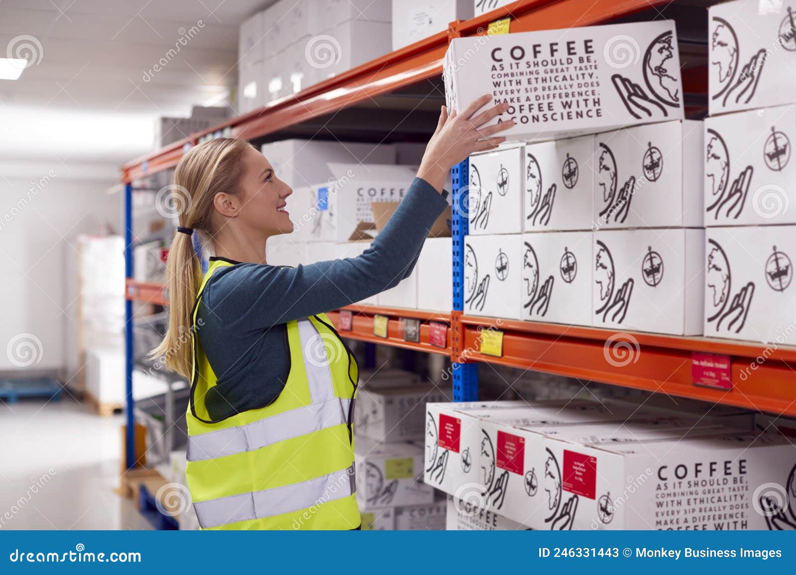 Female Worker Inside Busy Warehouse Putting Box Onto Shelf Stock Image ...