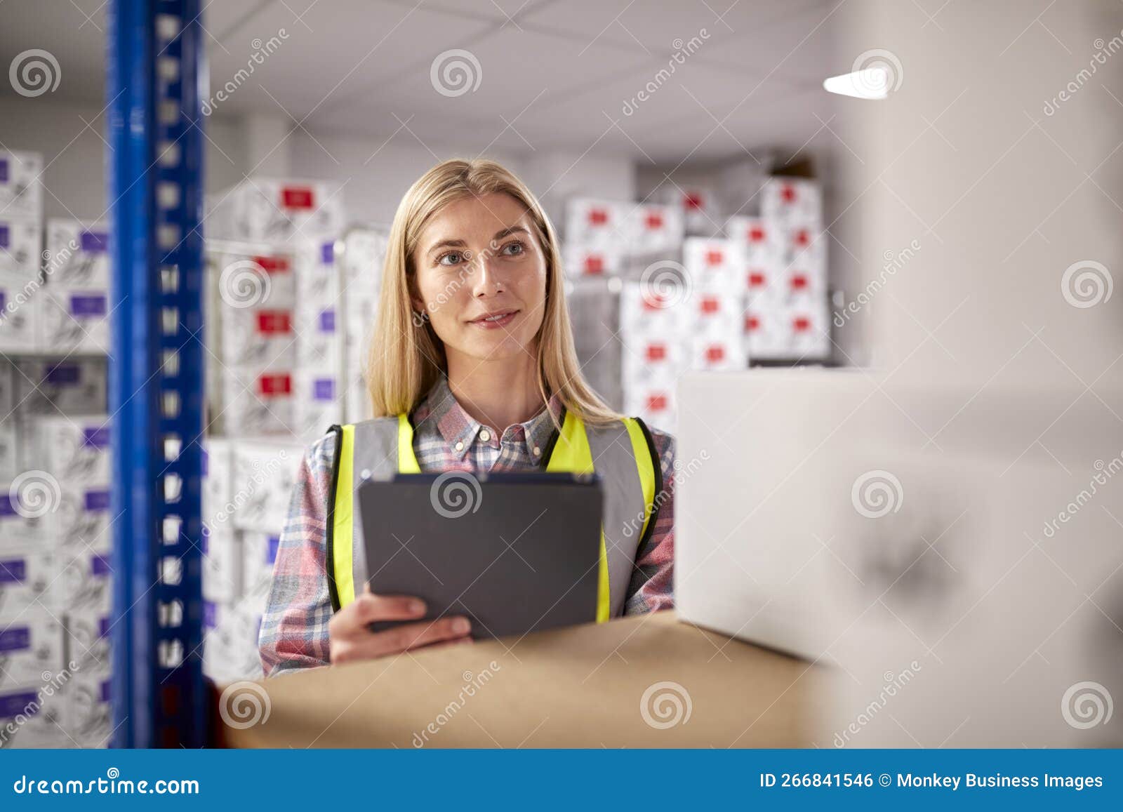 Female Worker in Logistics Distribution Warehouse Using Digital Tablet ...
