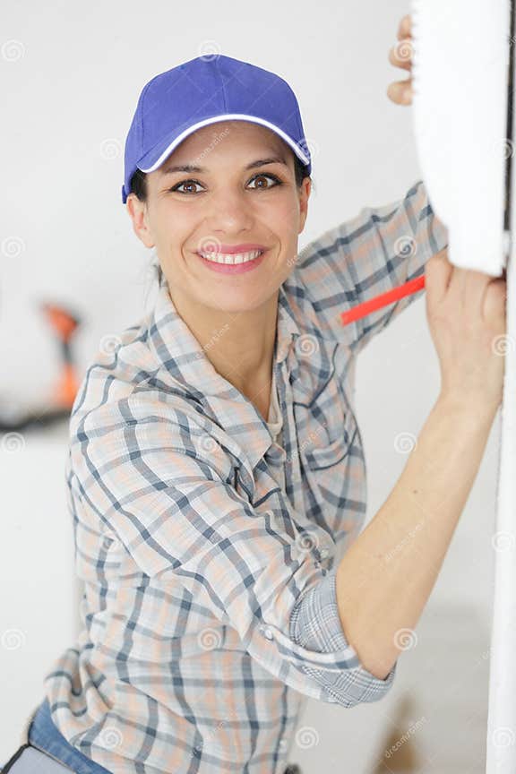 Female Worker Marking Position on Wall Stock Photo - Image of ...
