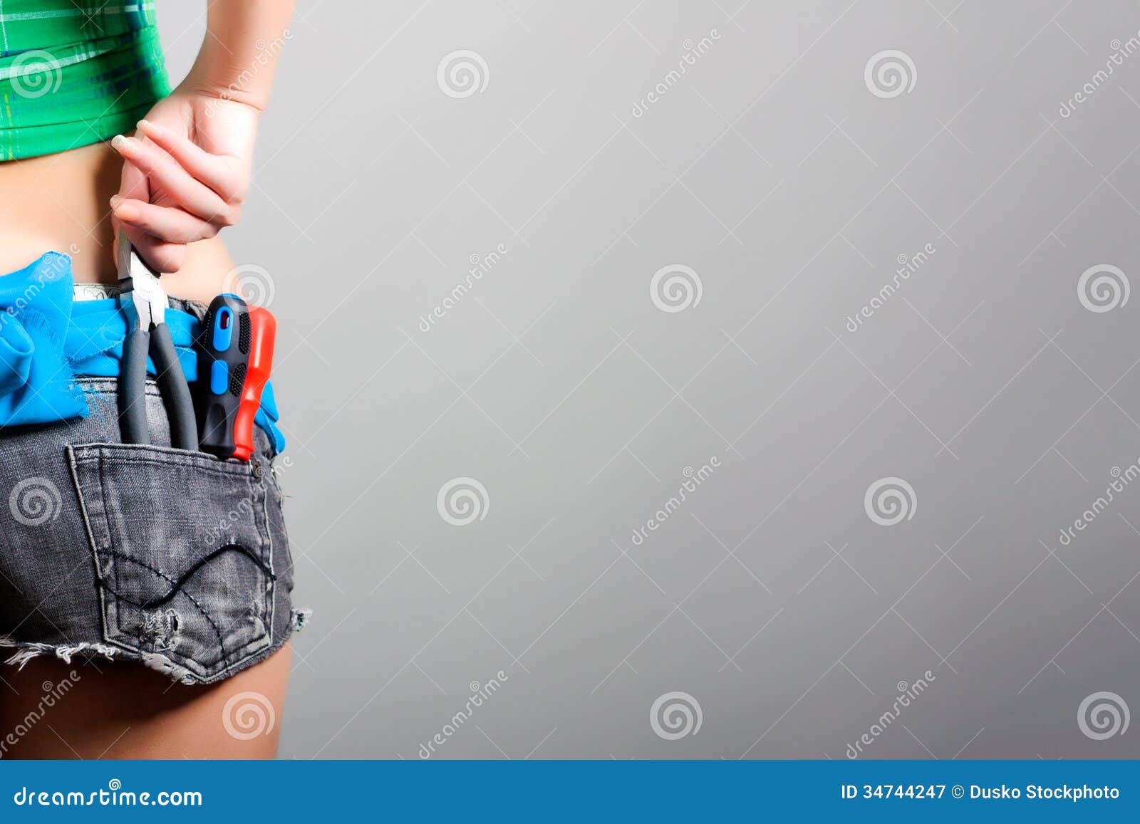 Female Worker with Pliers and Screwdrivers in Back Pocket Stock Image ...