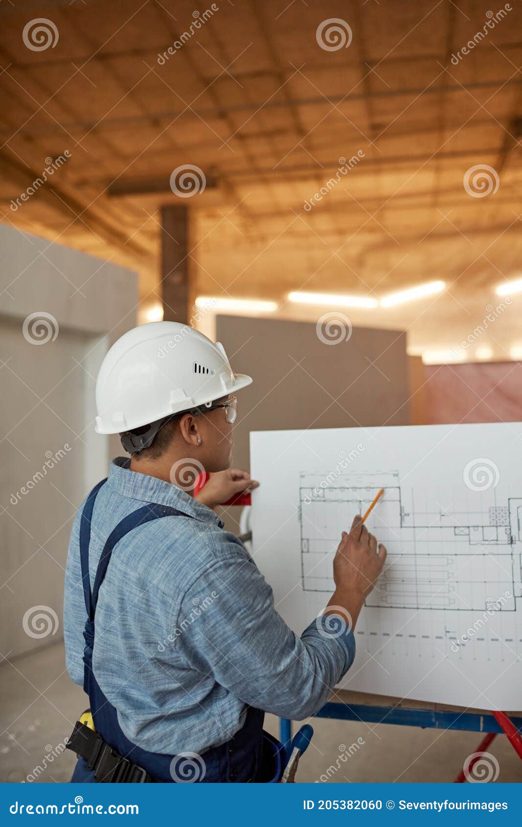 Female Worker Pointing at Plans on Site Stock Photo - Image of building ...