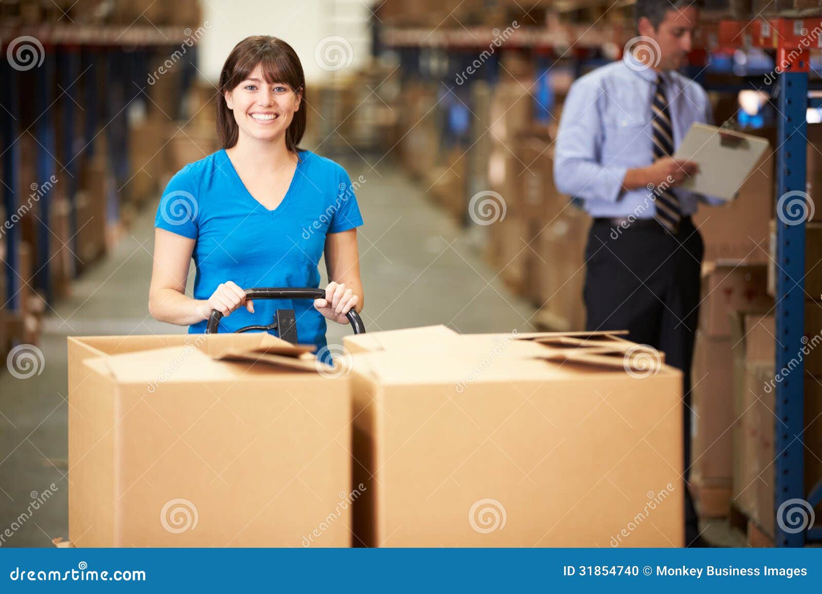 Female Worker Pulling Pallet In Warehouse Stock Photography ...