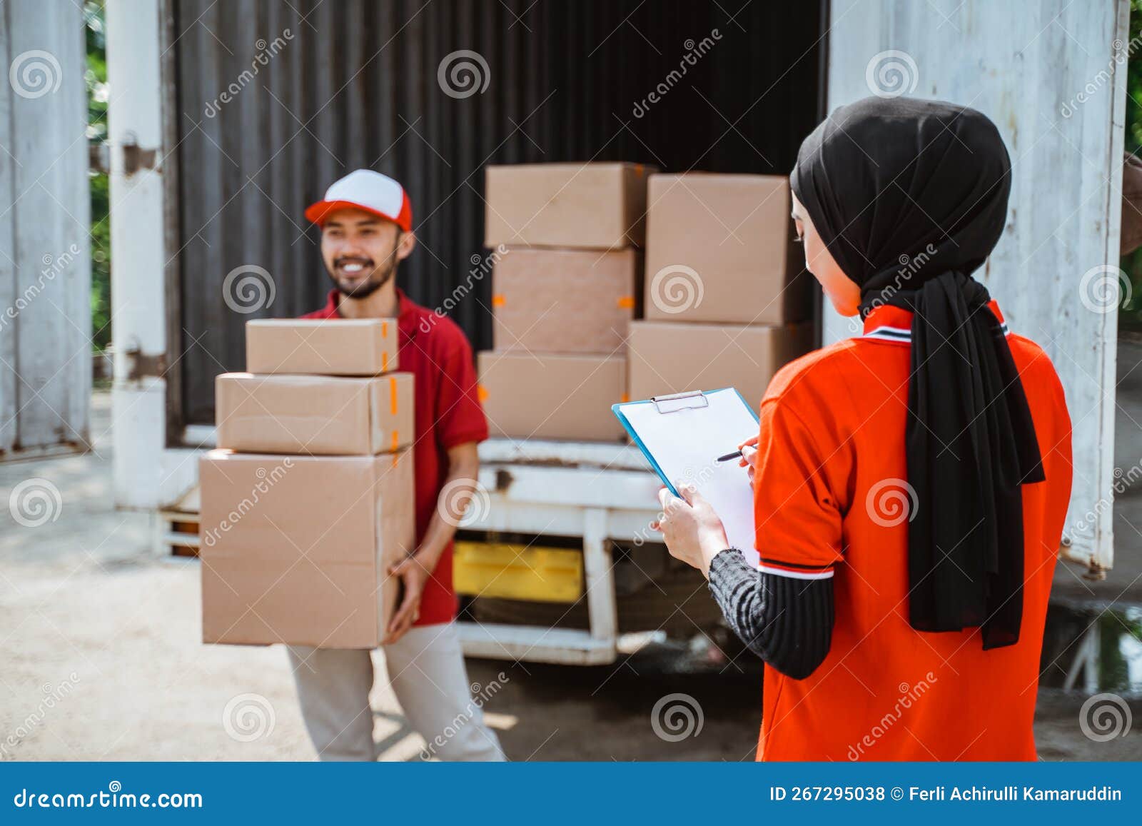 Female Worker with Notes Checking the Package by Delivery Man Stock ...
