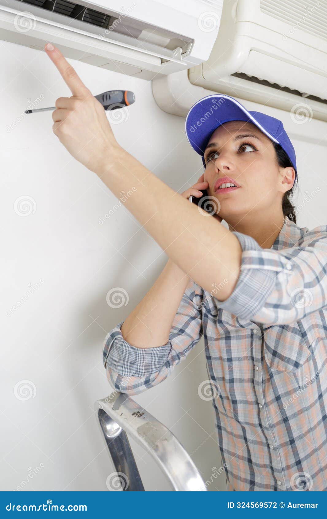 Female Worker Repairing Air Conditioner Stock Photo - Image of ...
