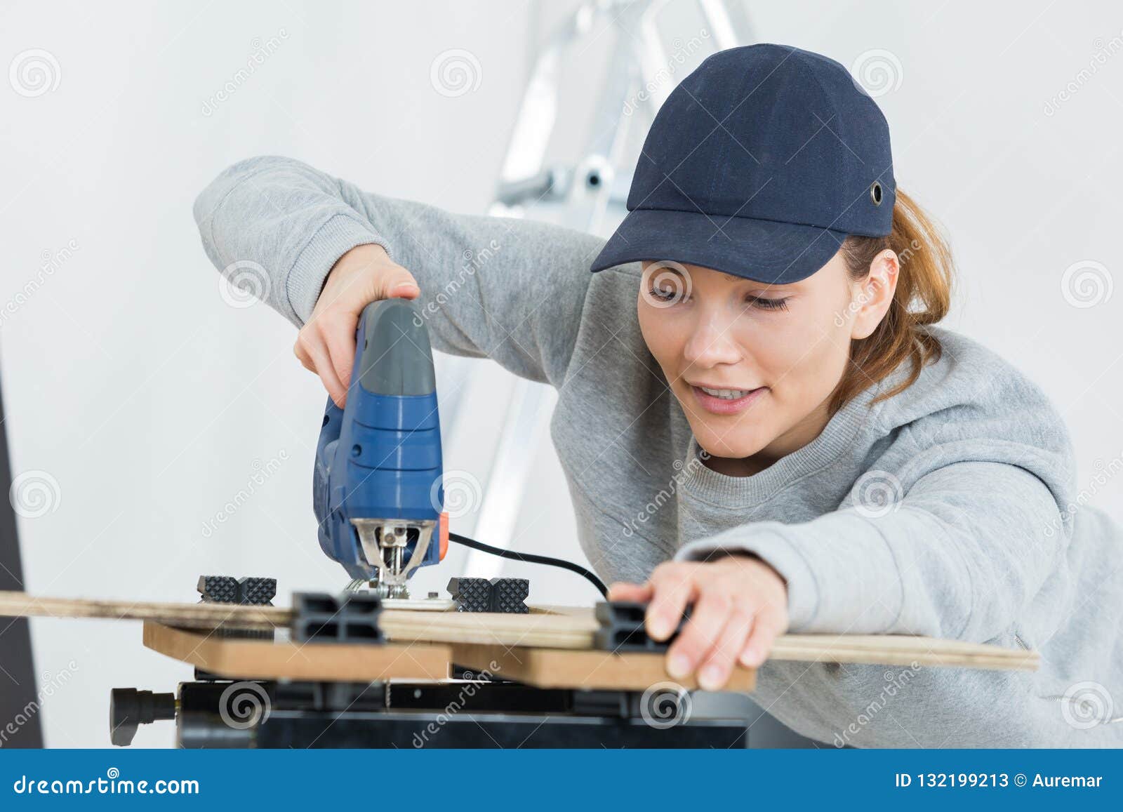 Female worker sawing wood stock image. Image of carpenter - 132199213