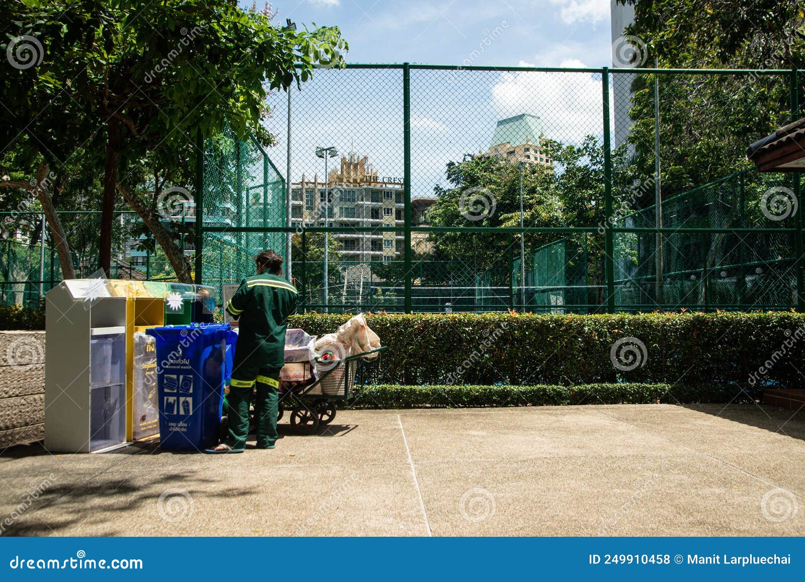 A Female Worker is Sorting Waste from Classified Waste Bins. Editorial ...