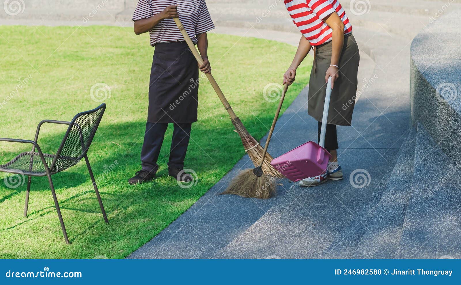 Female Worker Sweeping Yard With Broom Tool And Dustpan In Ornamental
