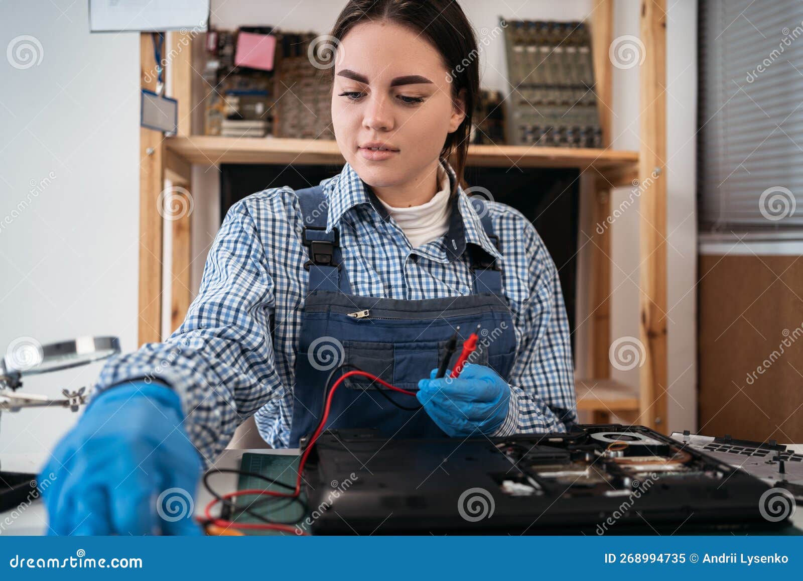 Female Worker Testing Laptop Motherboard Using Multimeter while Working ...