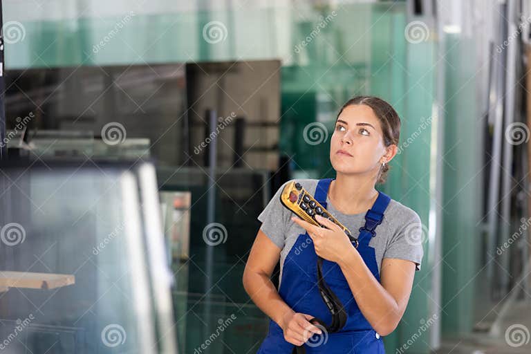 Female Worker Using Control Panel and Lifting Mechanism Controls ...
