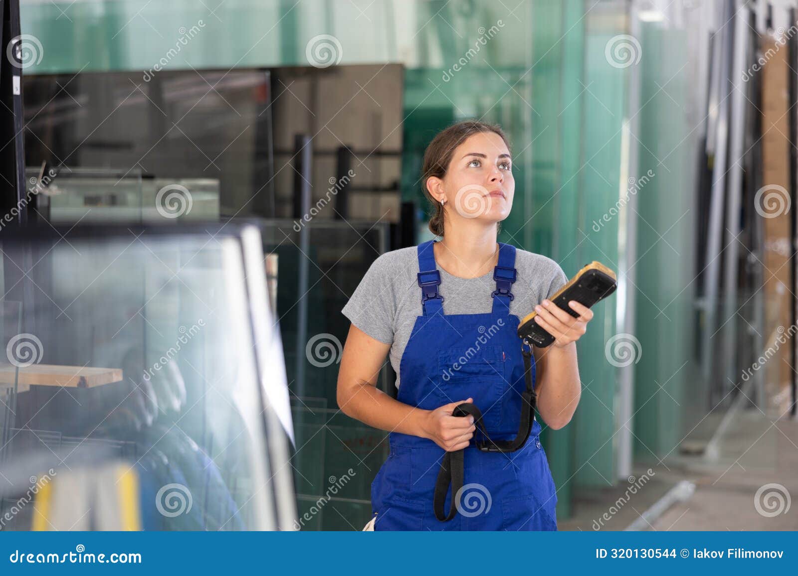 Female Worker Using Control Panel and Lifting Mechanism Controls ...