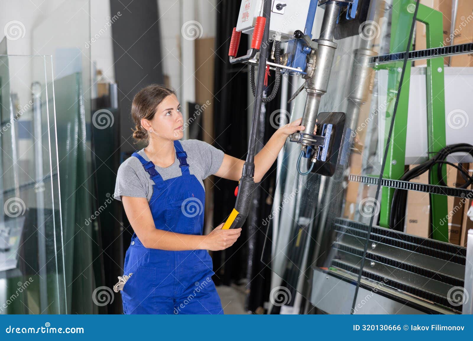 Female Worker Using Control Panel and Lifting Mechanism Controls ...