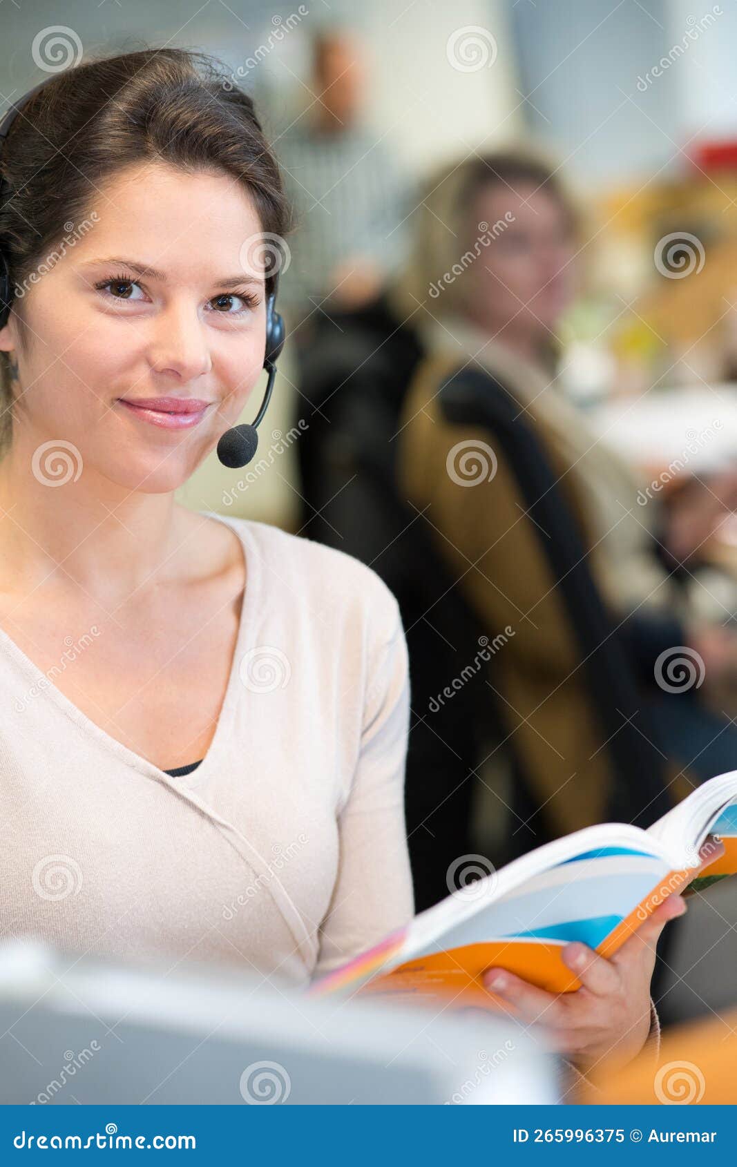 Female Worker Wearing Headset and Holding Book Stock Image - Image of ...