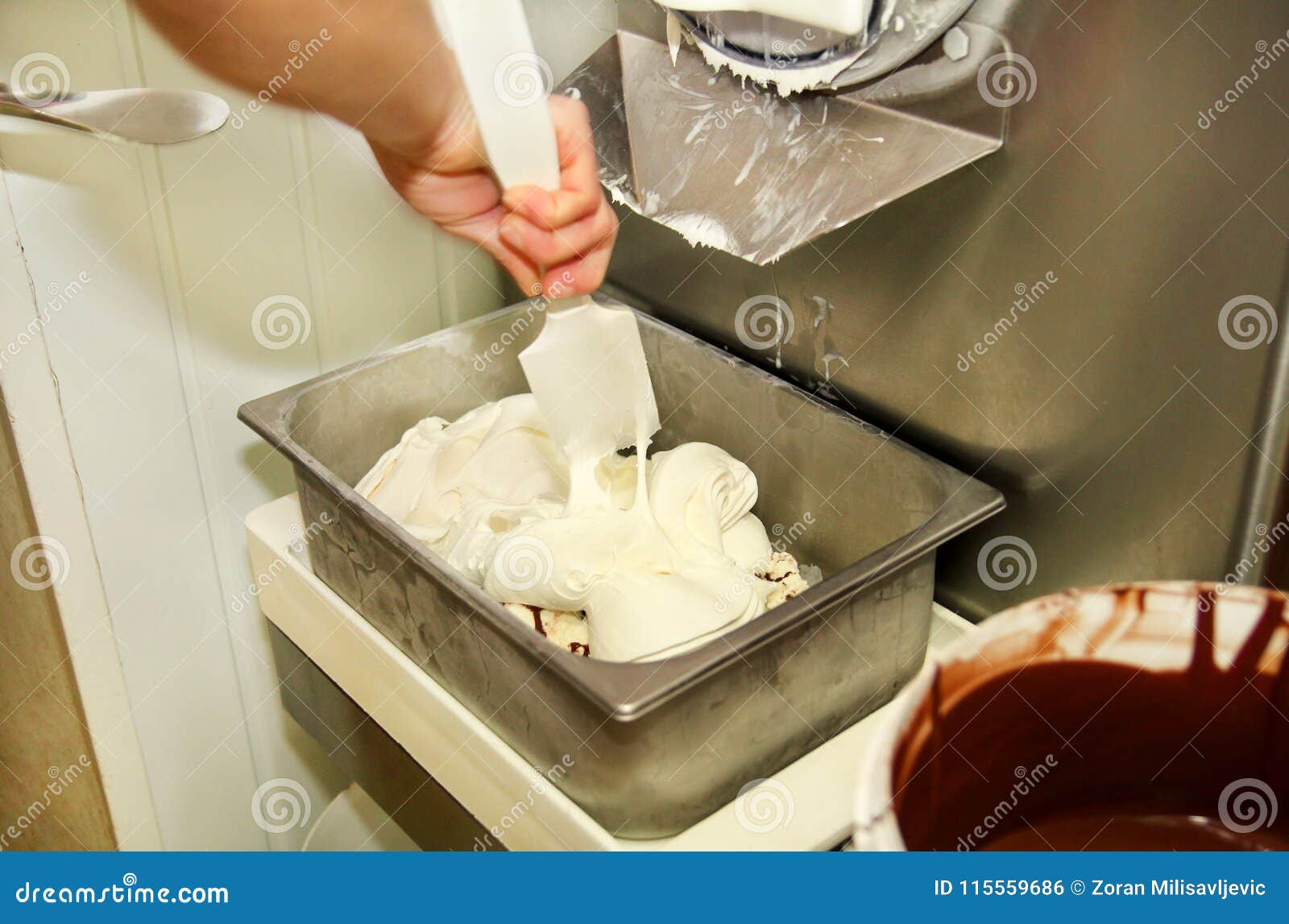 Female Worker is Working on Ice Cream Maker Machine. Producing Vanilla ...