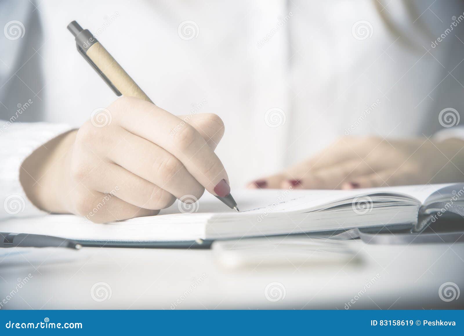Female writing in notepad stock image. Image of business - 83158619