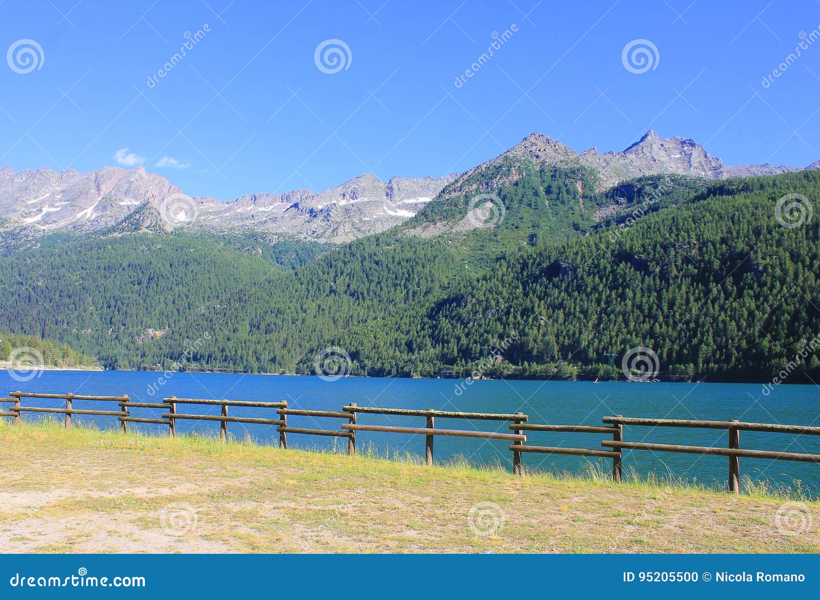 Fence Around the Lake in Front of Mountains Stock Photo - Image of ...