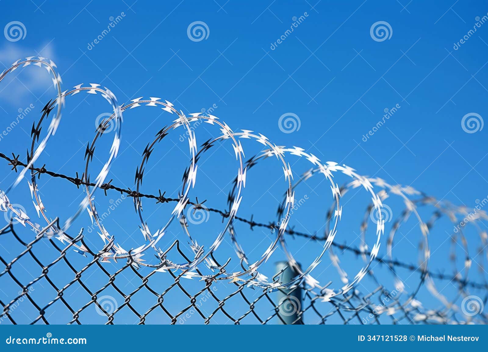 Fence with Barbed Wire Against a Background of Blue Sky, Protected ...