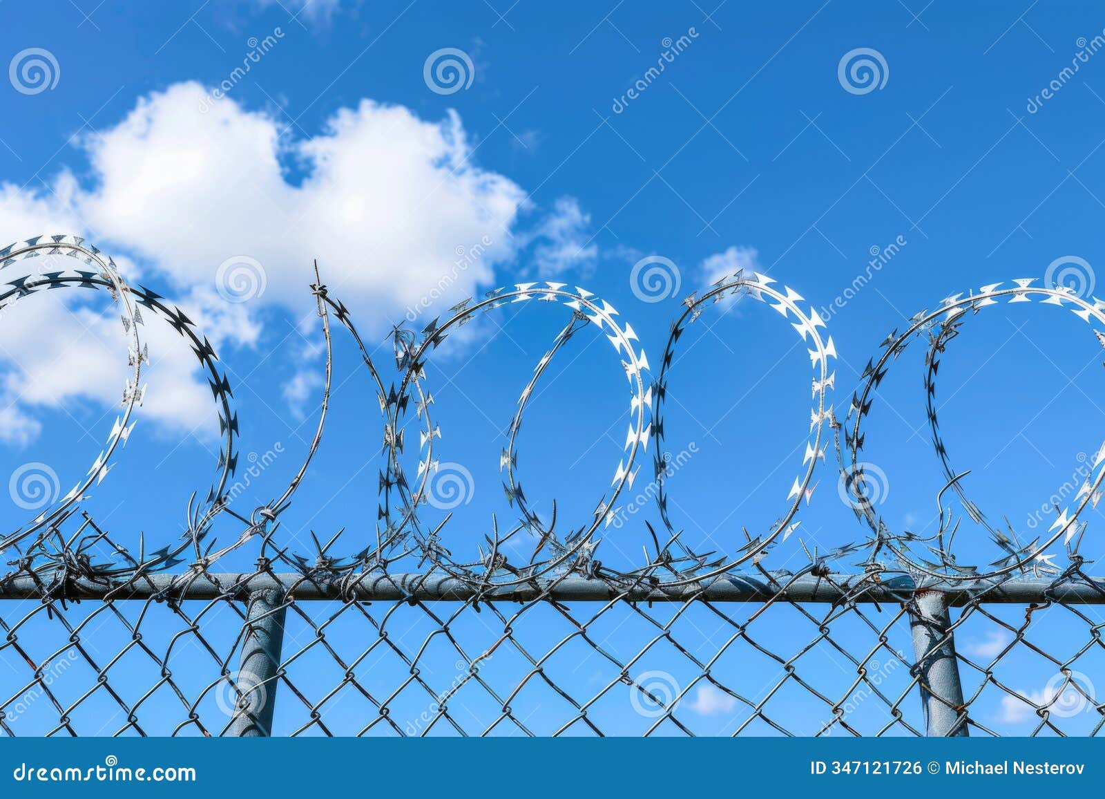 Fence with Barbed Wire Against a Background of Blue Sky, Protected Object Stock Photo - Image of ...