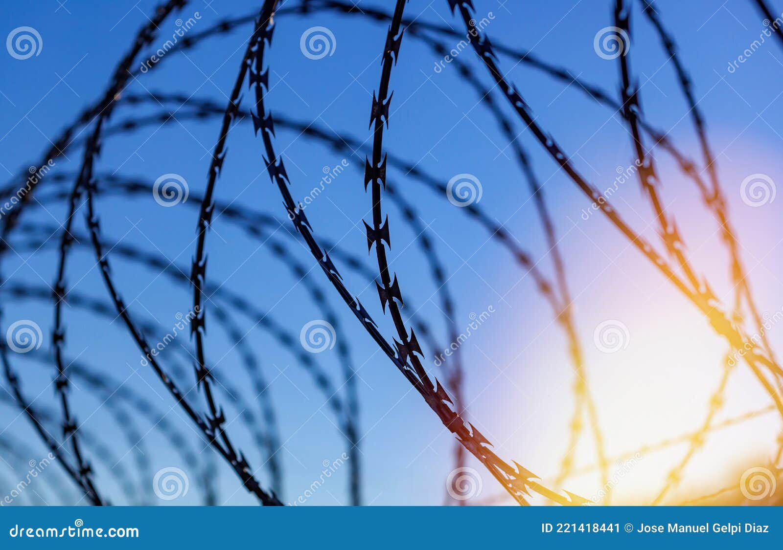 Fence with a Barbed Wire Under Stock Image - Image of blue, metal ...