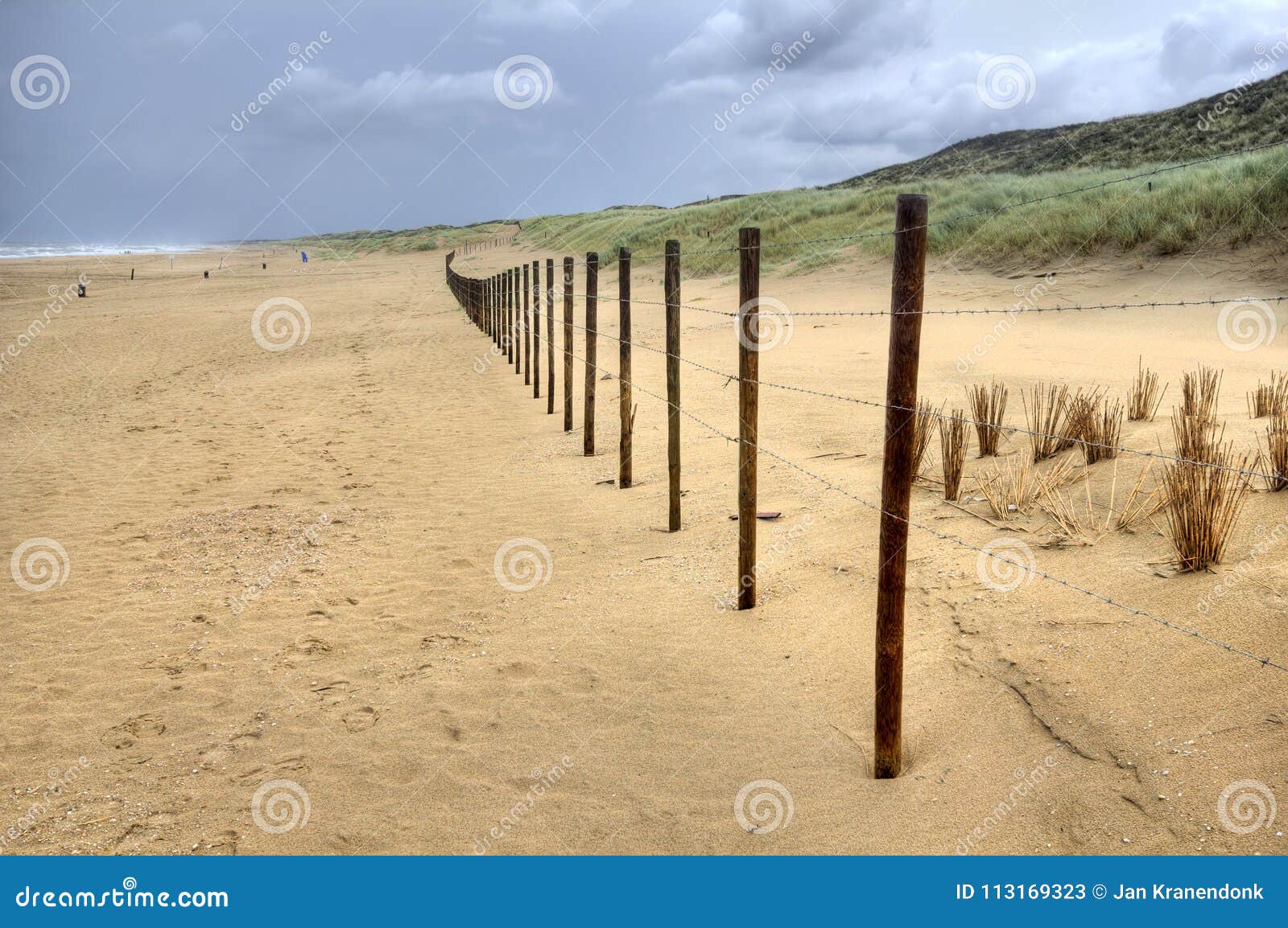 Fence on beach in Holland stock image. Image of dunes - 113169323