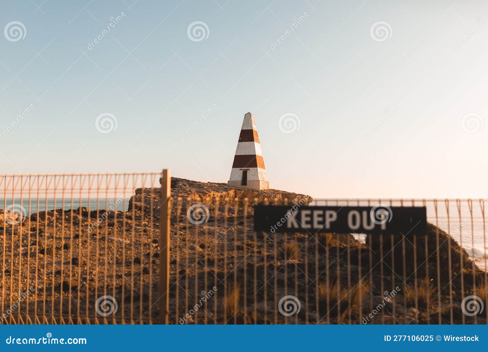 Fence with a Keep Out Sign Situated in Front of a Lighthouse in the ...