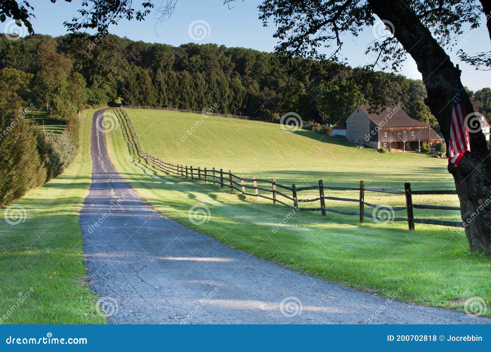 Fence Lined Road Leading To Farm and Fields Stock Photo - Image of ...