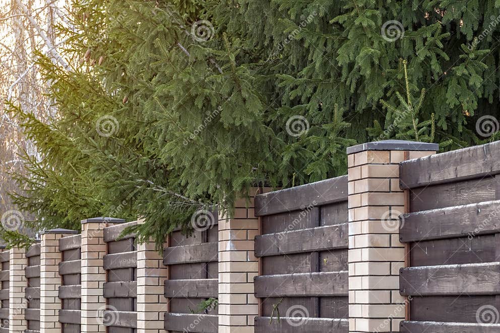A Fence Made of Bricks and Boards Stock Photo - Image of building ...