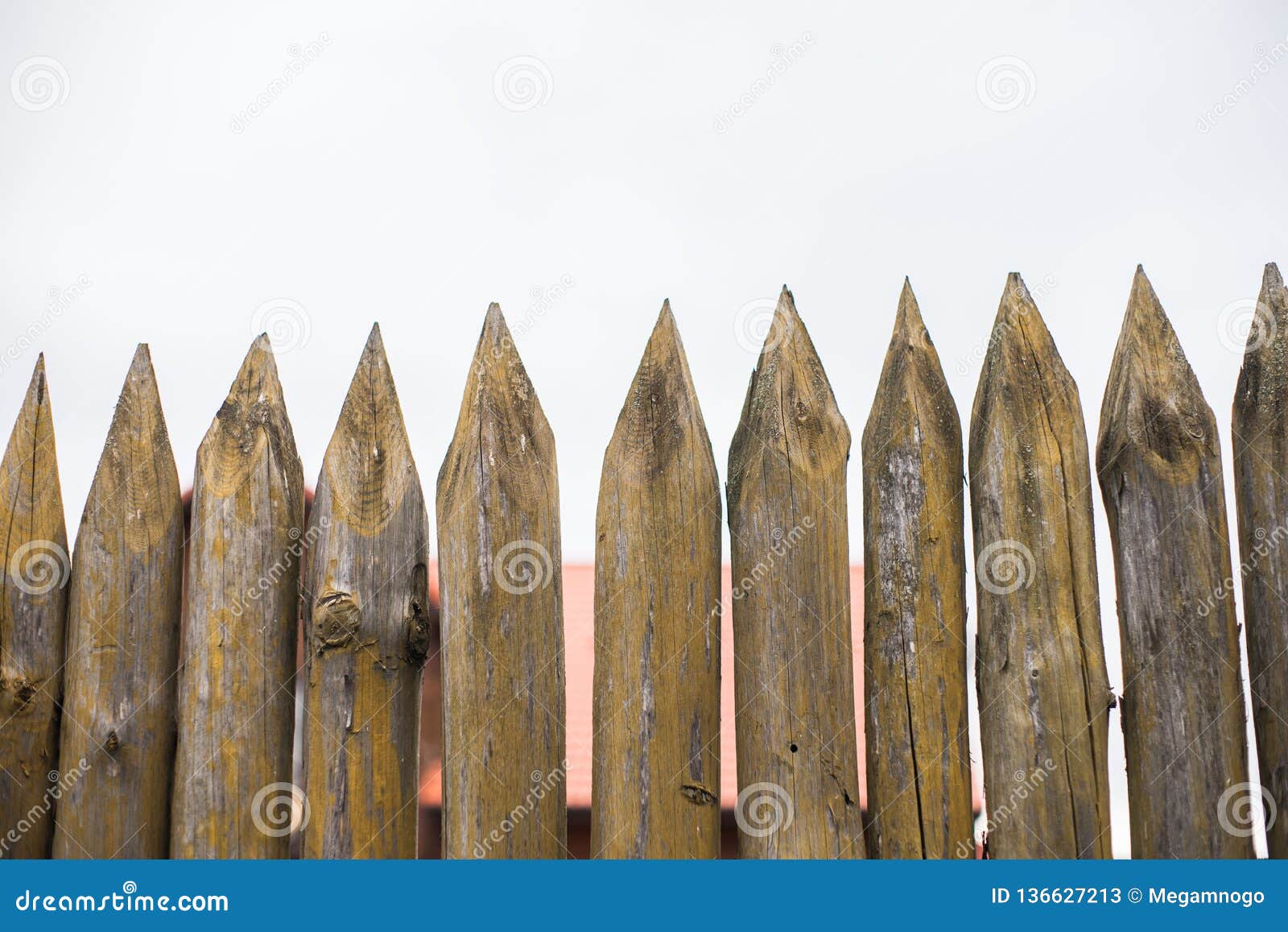 Fence Made of Sharp Wooden Stakes Against the Grey Sky Stock Image ...