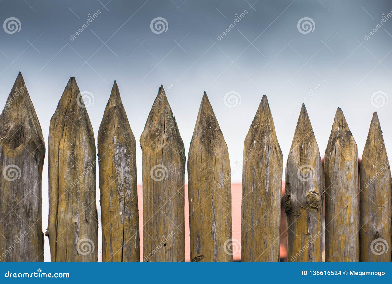 Fence Made of Sharp Wooden Stakes Against the Grey Sky Stock Photo ...