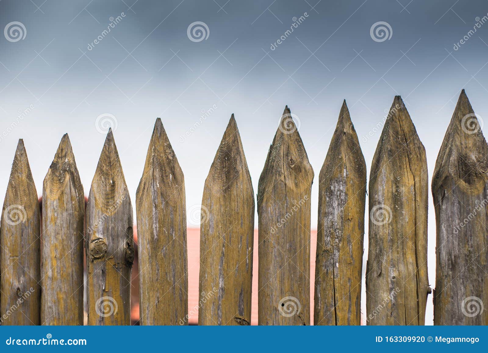 Fence Made of Sharp Wooden Stakes Against the Grey Sky Stock Photo ...