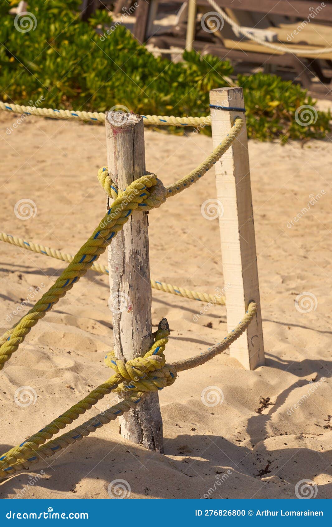 A Fence of Painted White Boards and a Yellow Rope in the Sand. Stock ...