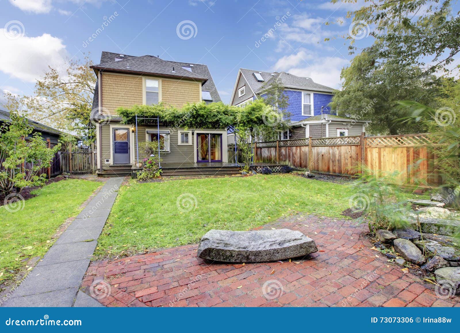 Fenced Backyard with Lawn, Covered Walkway and Open Terrace Stock Photo ...