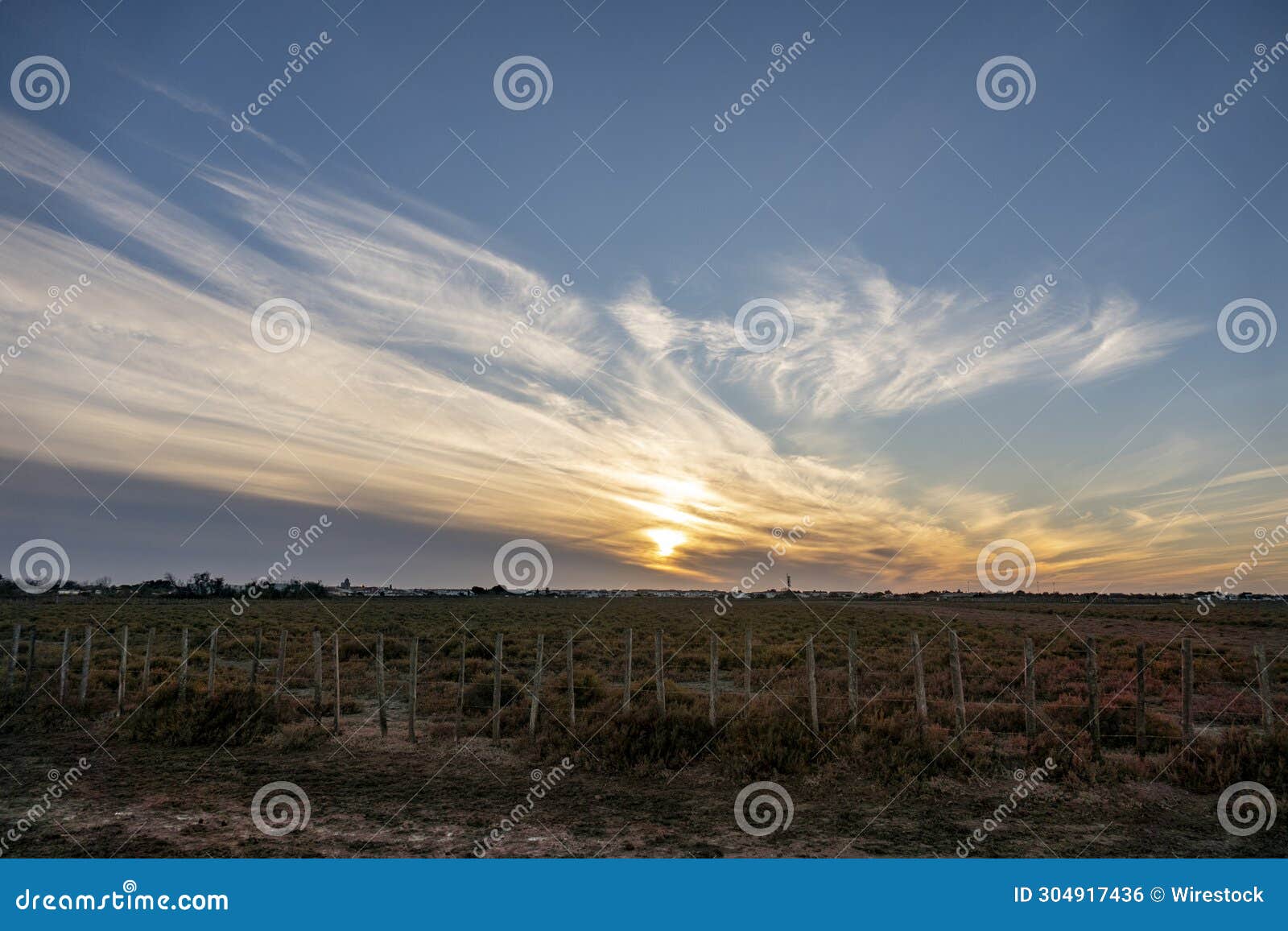 Fenced Field Under a Captivating Sunset Sky with Stunning Cloud ...