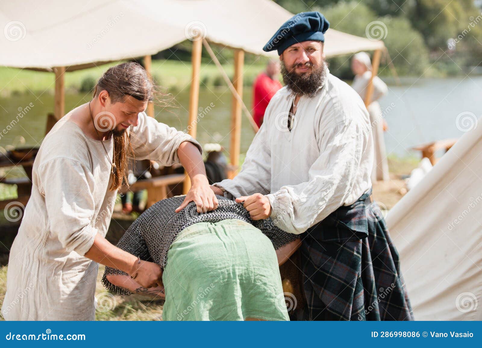 Helping a Warrior Take Off His Chain Mail - Squires Editorial Photo ... Helping a Warrior Take Off His Chain Mail - Squires Editorial Photo ...