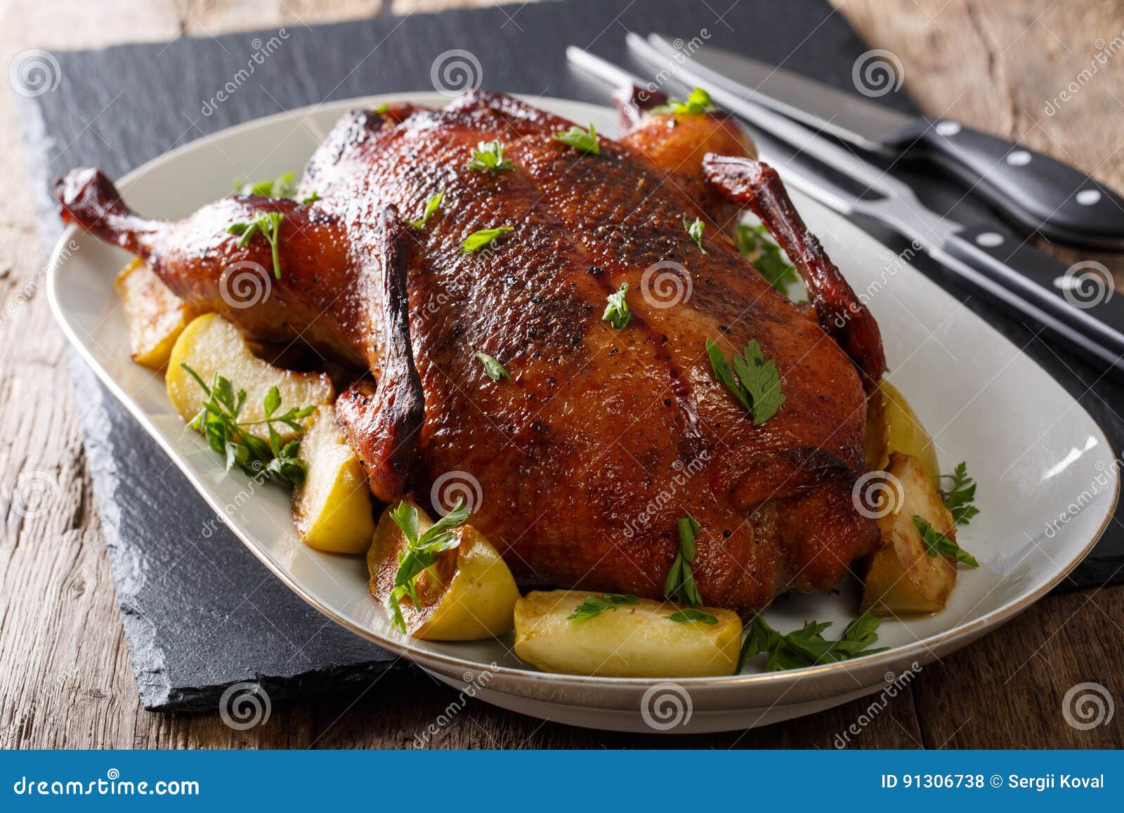 Festive Baked Duck with Apples Close-up on a Table. Horizontal Stock ...