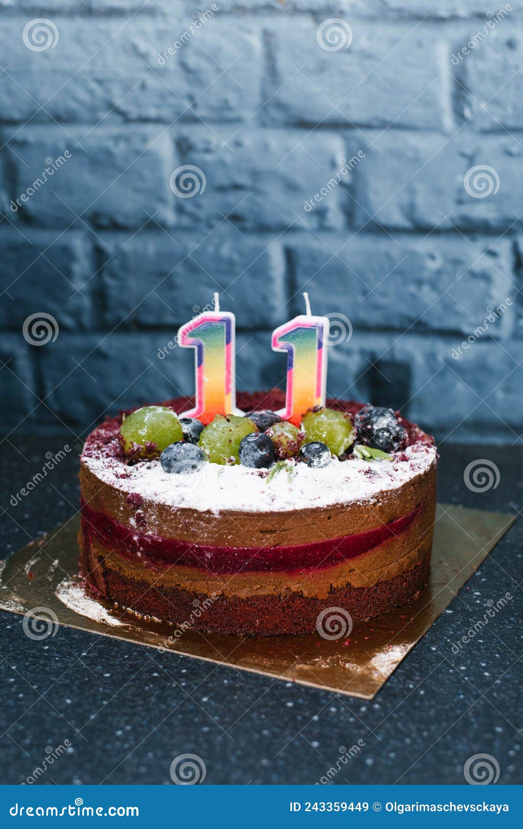 A Festive Fruit Cake with Candles with Numbers 11 on a Blue Table Stock ...