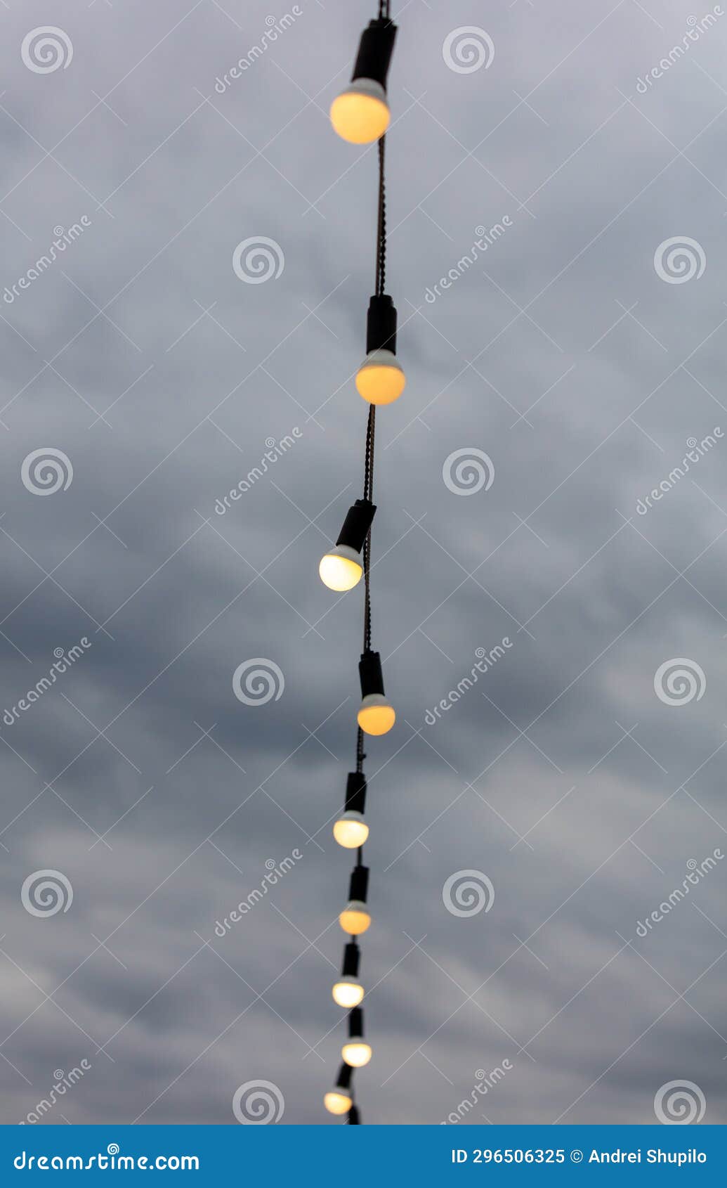 Festive Light Bulbs Shine Against the Background of the Sky with Clouds ...