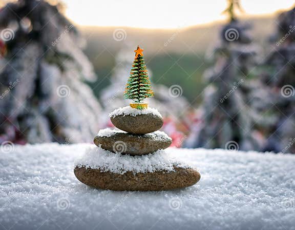 Festive Stack of Pebbles with Mini Christmas Tree and Snow-Covered ...