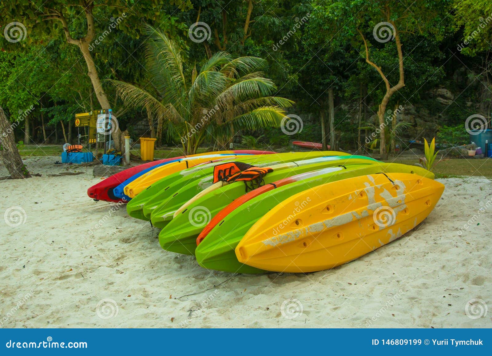 A Few Upside Down Kayaks with Life Jacket on Them Laying on a Sandy ...
