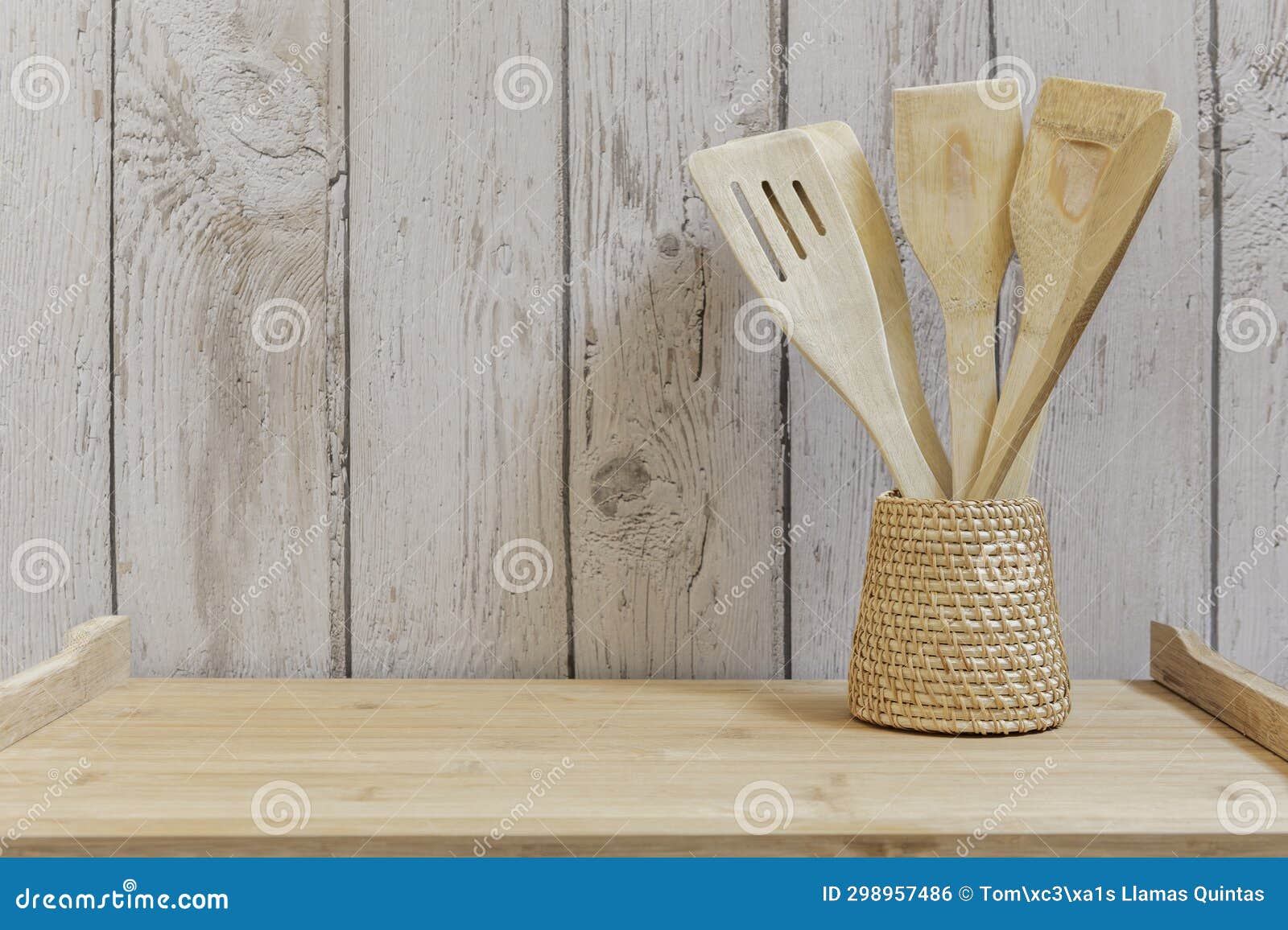 A Fiber and Cane Container with Wooden Spatulas for Cooking on a Bamboo ...
